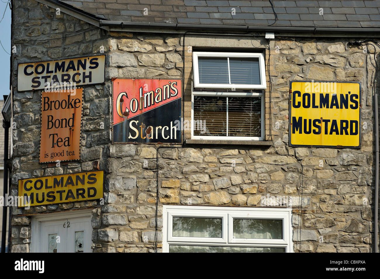Old signs on the side of a house Stock Photo - Alamy
