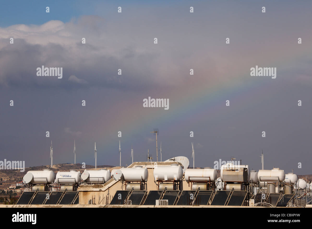 Rainbow over environmentally friendly wind farm and solar heating ...