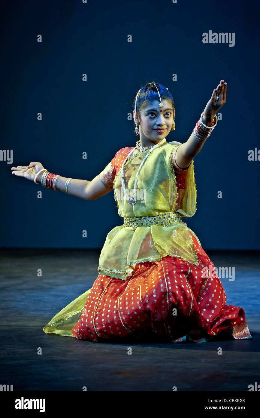 Asian Indian dancer performing on stage wearing traditional costume ...