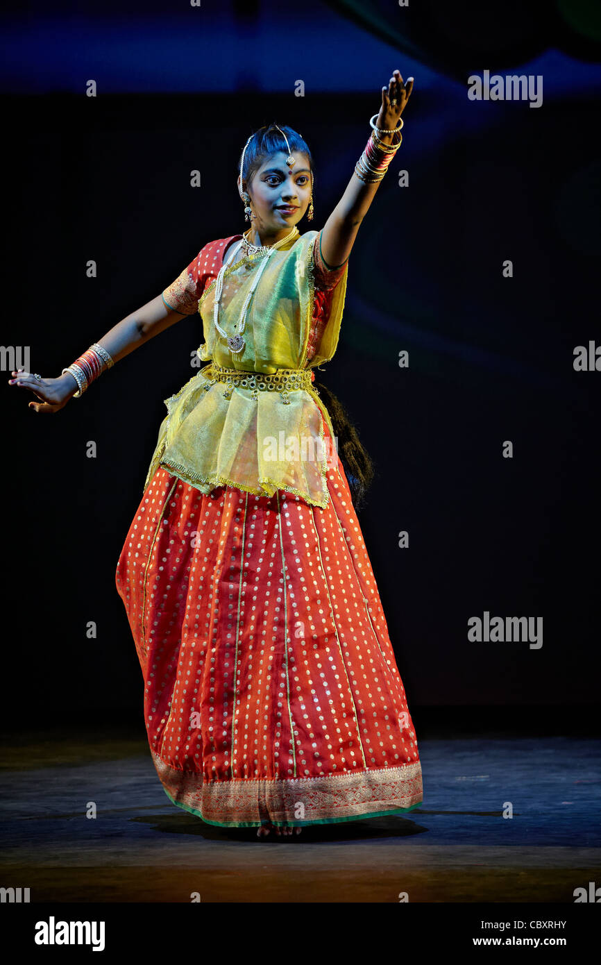 Asian Indian dancer performing on stage wearing traditional costume ...