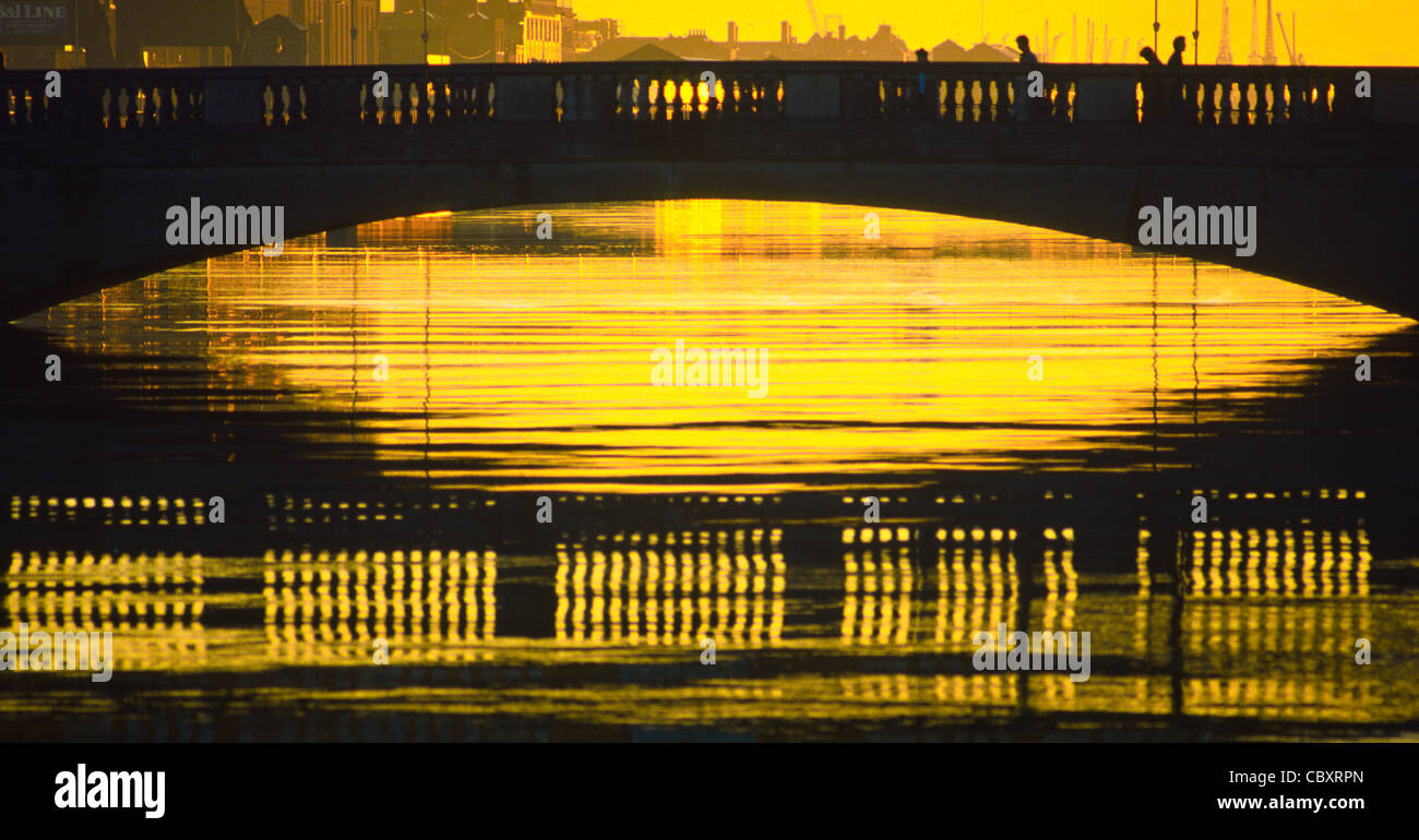 Early morning bridge traffic over the River Liffey at Port of Dublin in ...