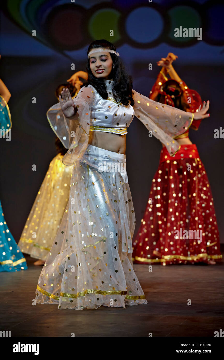 Asian Indian dancer performing on stage wearing traditional costume ...