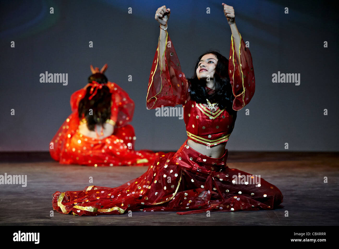 Asian Indian dancer performing on stage wearing traditional costume ...