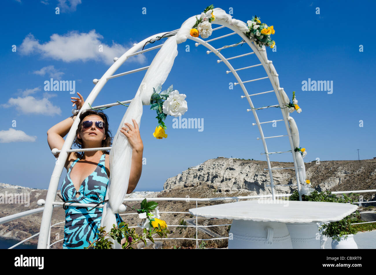Beautiful model leaning against railing in Santorini,Cyclades Islands ...