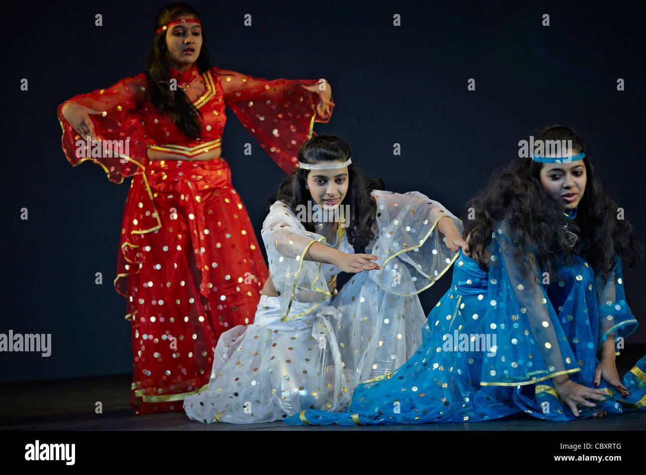 Asian Indian dancer performing on stage wearing traditional costume ...