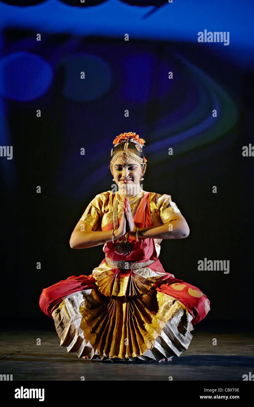 Asian Indian dancer performing on stage wearing traditional costume ...