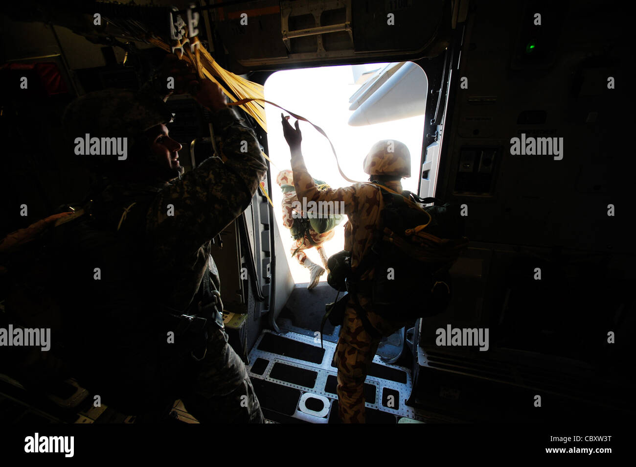 Paratroopers begin their "friendship jump" from a U.S. Air Force C-17 ...