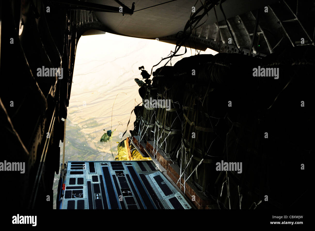 Pallets of cargo drop from a C-17 Globemaster III to a forward ...
