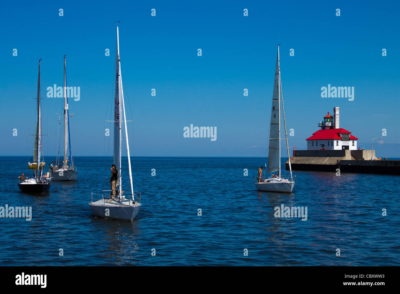Sailboat returning to harbor Stock Photo - Alamy