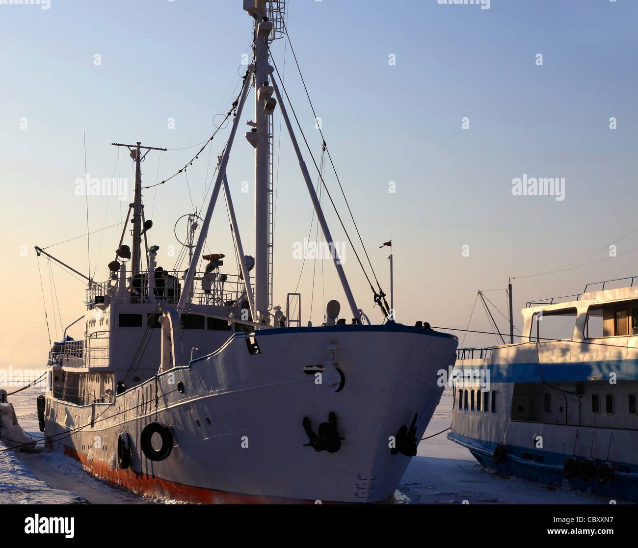 Frozen port. Winter. Two ships. Lake Baikal Stock Photo - Alamy