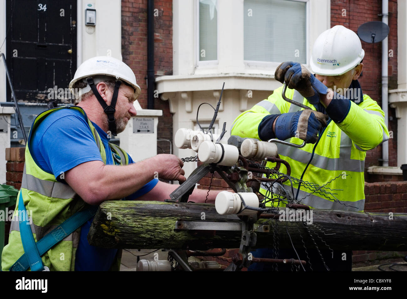 telephone engineers at work replacing old chandelier style telephone ...