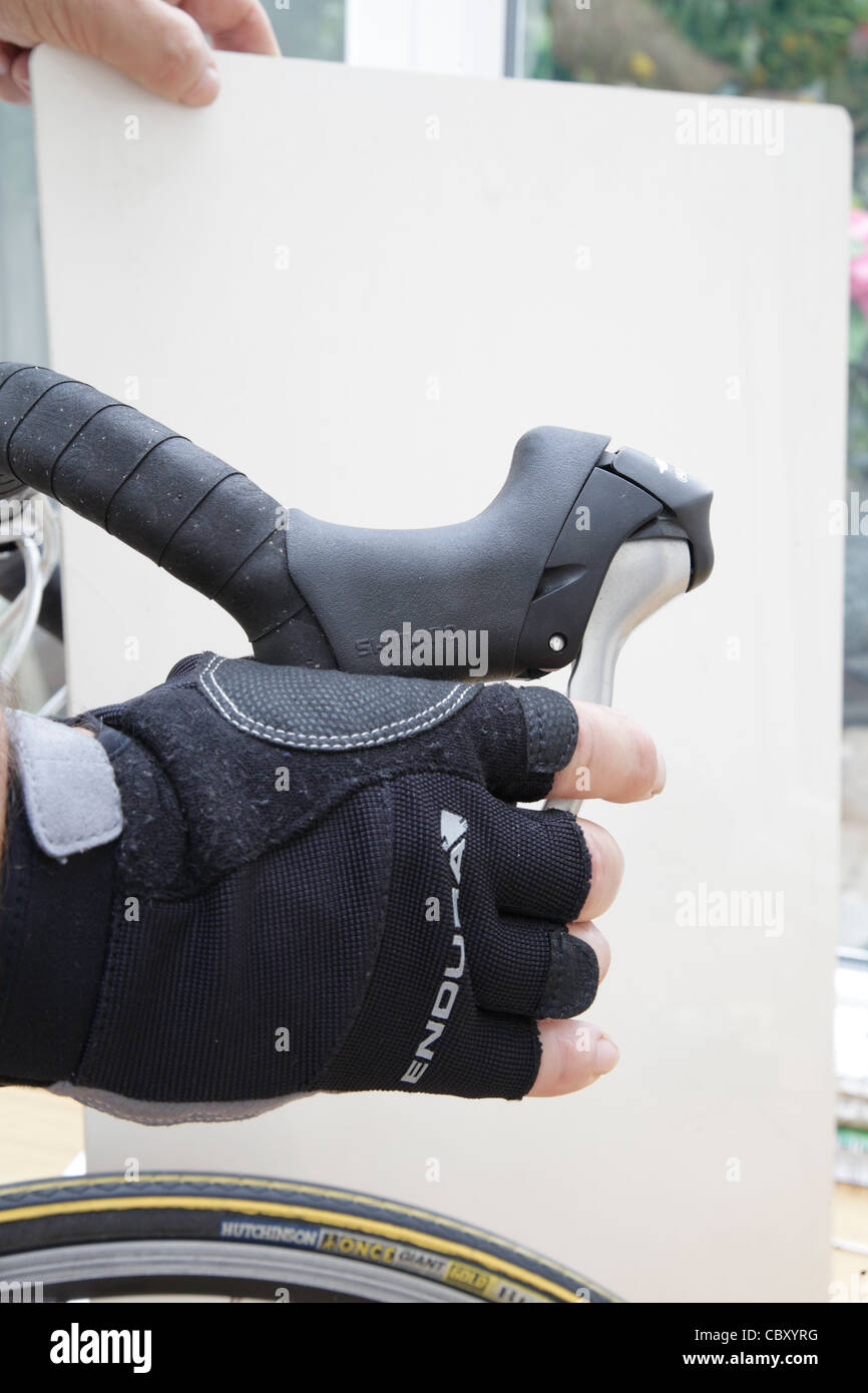 man's hand wearing glove mitt fingerless gloves holding racing bike ...