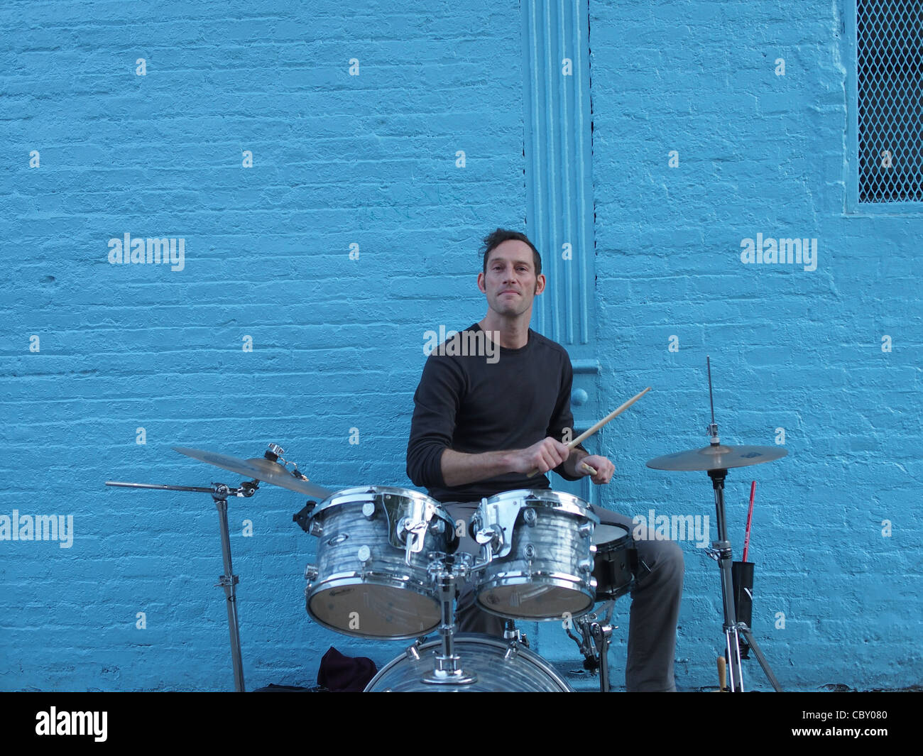 Street drummer in front of blue wall, Brooklyn, New York Stock Photo ...
