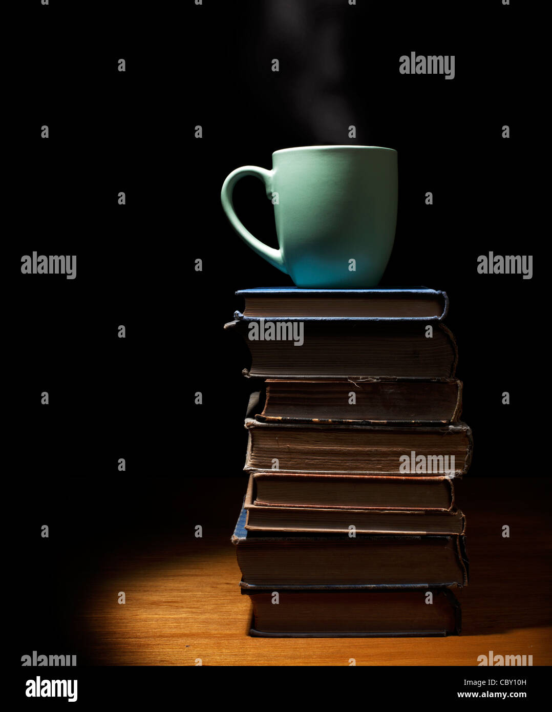 Coffee cup on Stack of books Stock Photo - Alamy