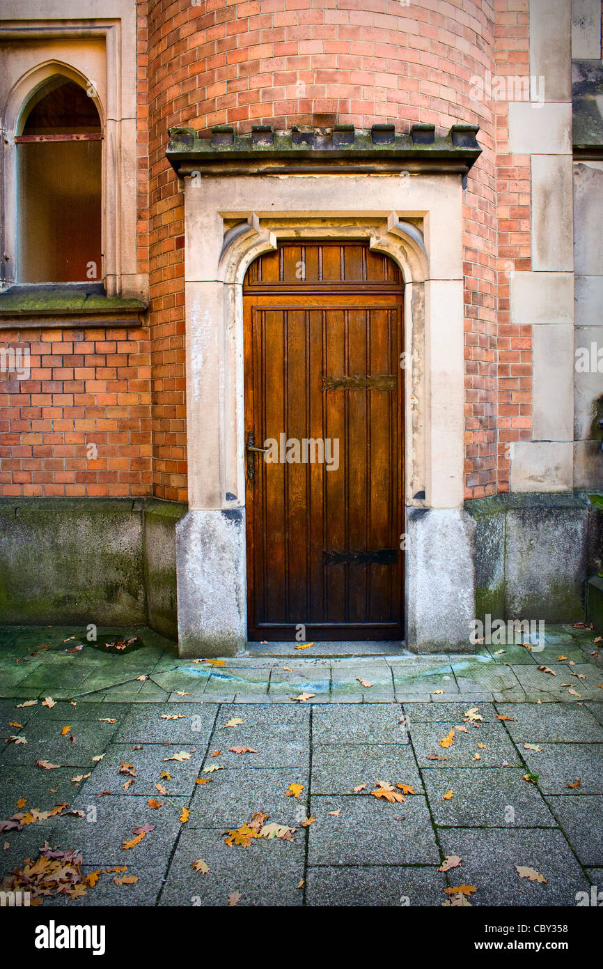 wooden church door with stone surround and brick wall Stock Photo - Alamy