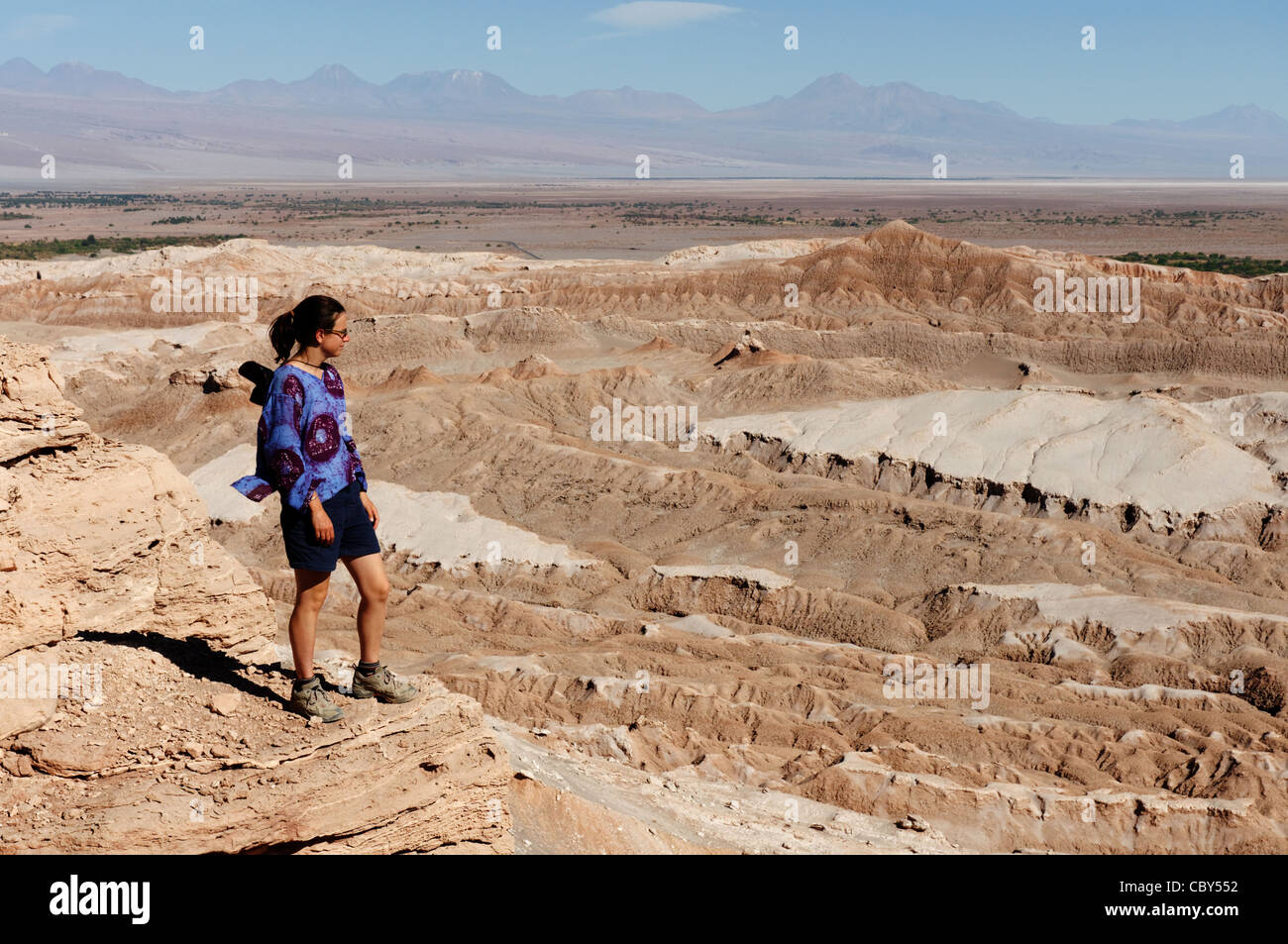 A young woman on a cliff overlooking the Atacama desert in Chile Stock ...