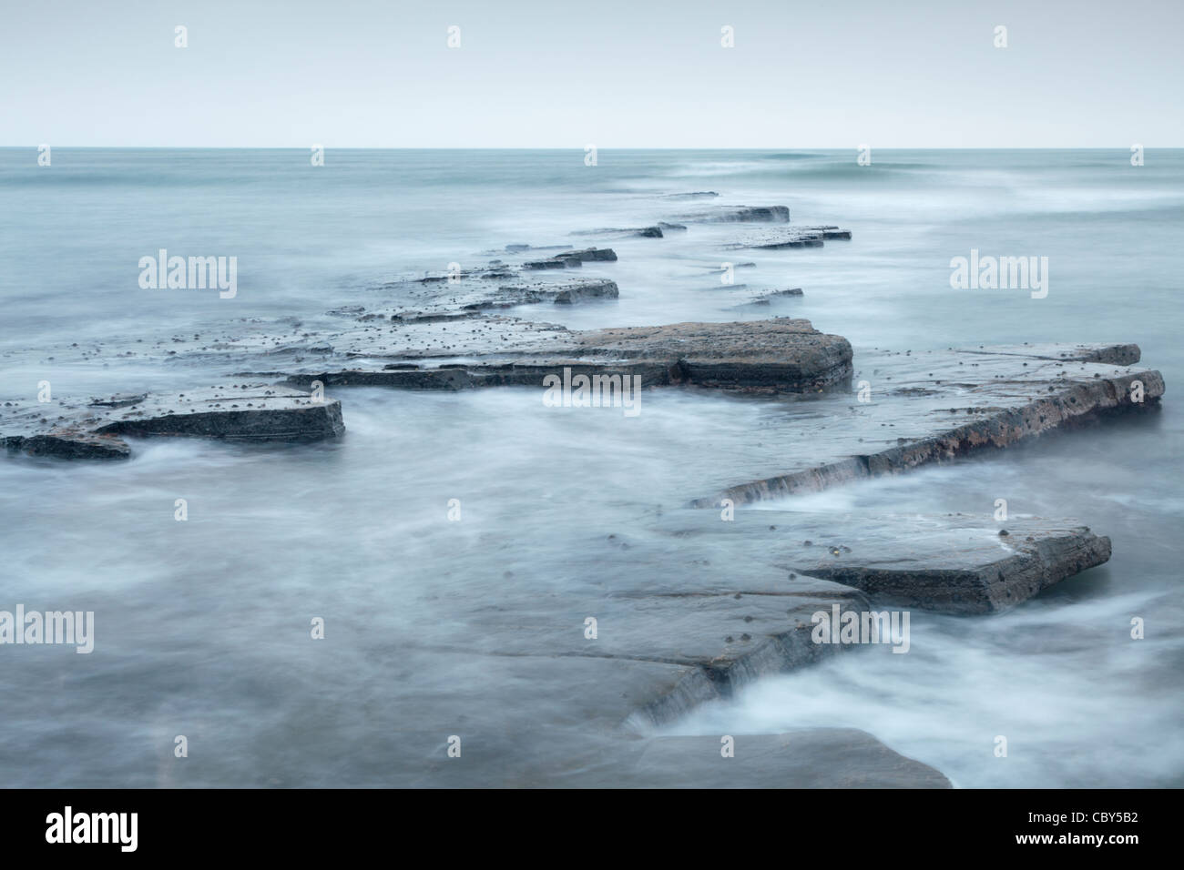 Waves washing over the rocks Stock Photo - Alamy