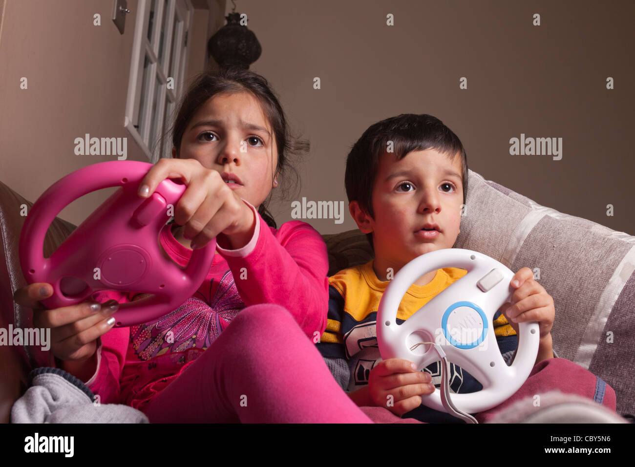 Siblings playing computer game at home Stock Photo - Alamy