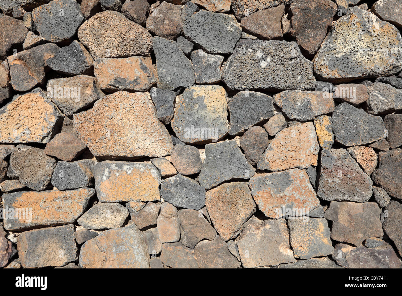 Volcanic stone wall, great for background and texture Stock Photo - Alamy