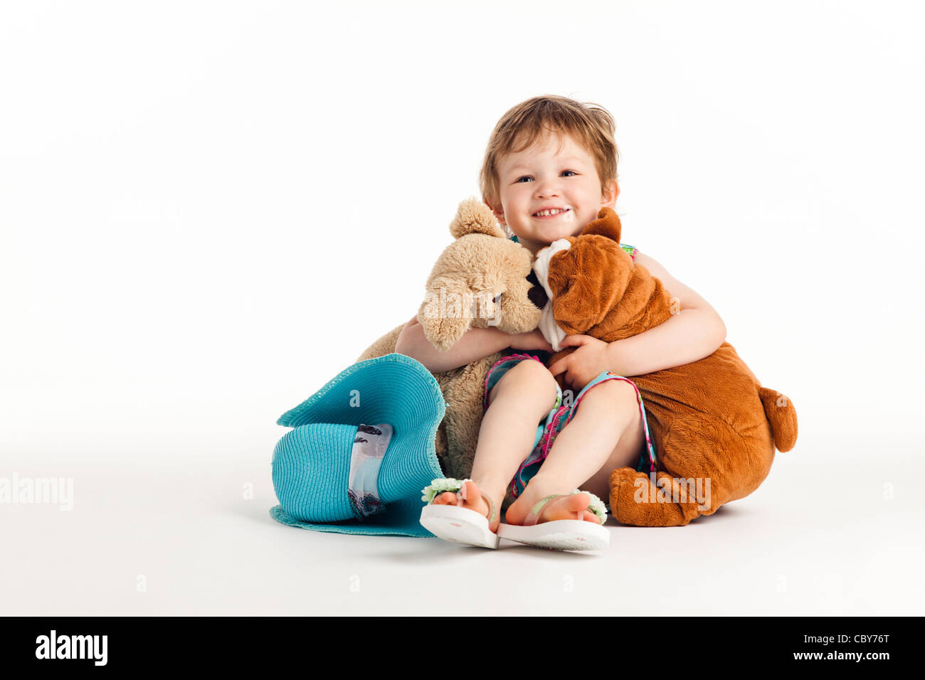 Happy child hugging his stuffed animals Stock Photo - Alamy