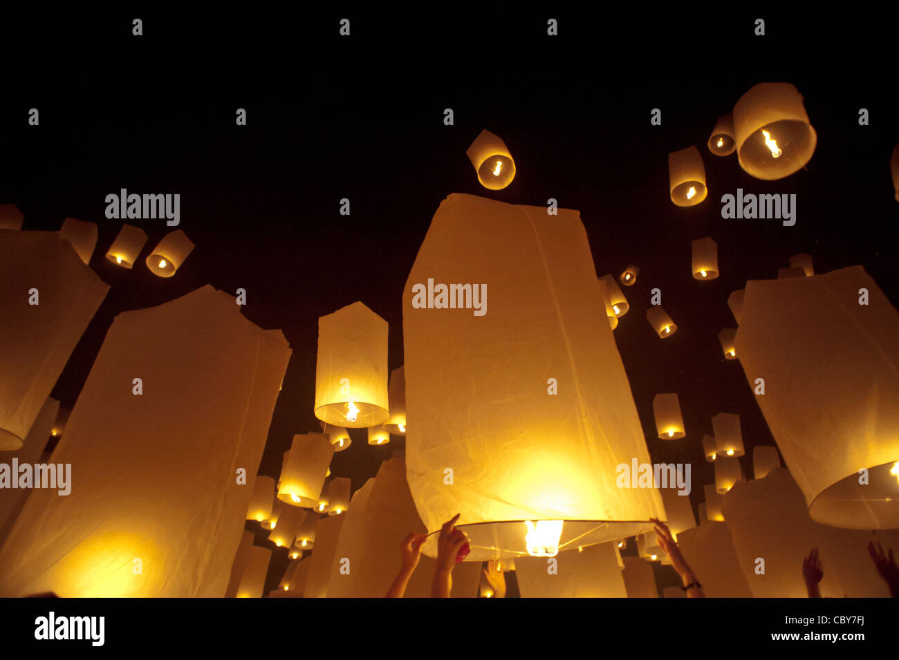 Traditional fire lanterns being released into the night sky during the ...