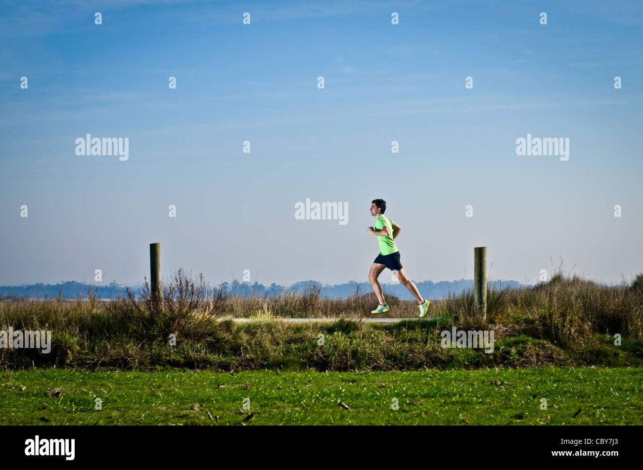 Male runner at sprinting speed training for marathon outdoors on ...