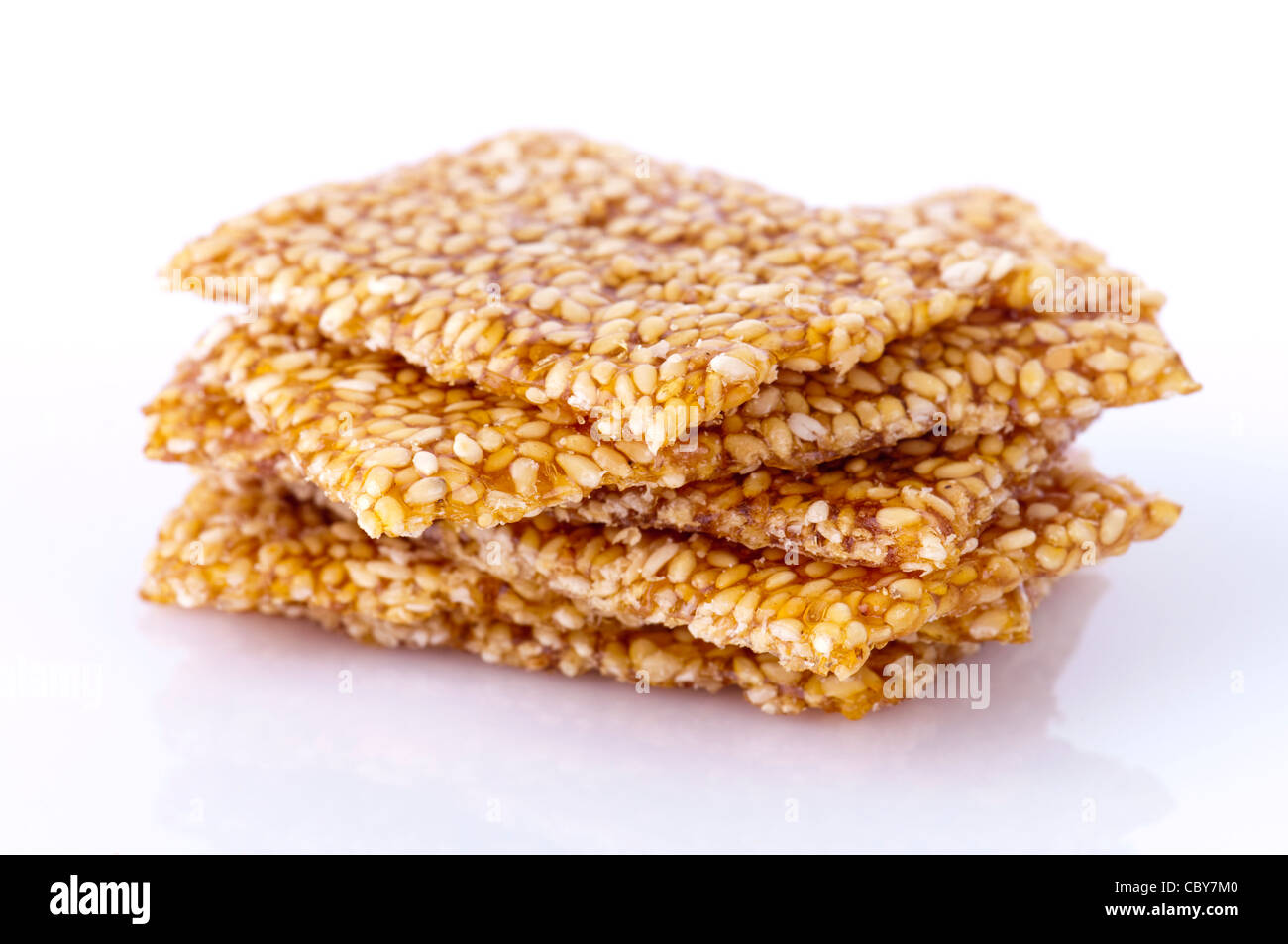 Sweet sesame snack on white background Stock Photo - Alamy