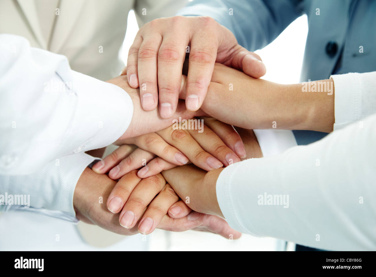 Image of businesspeople hands on top of each other as symbol of their ...