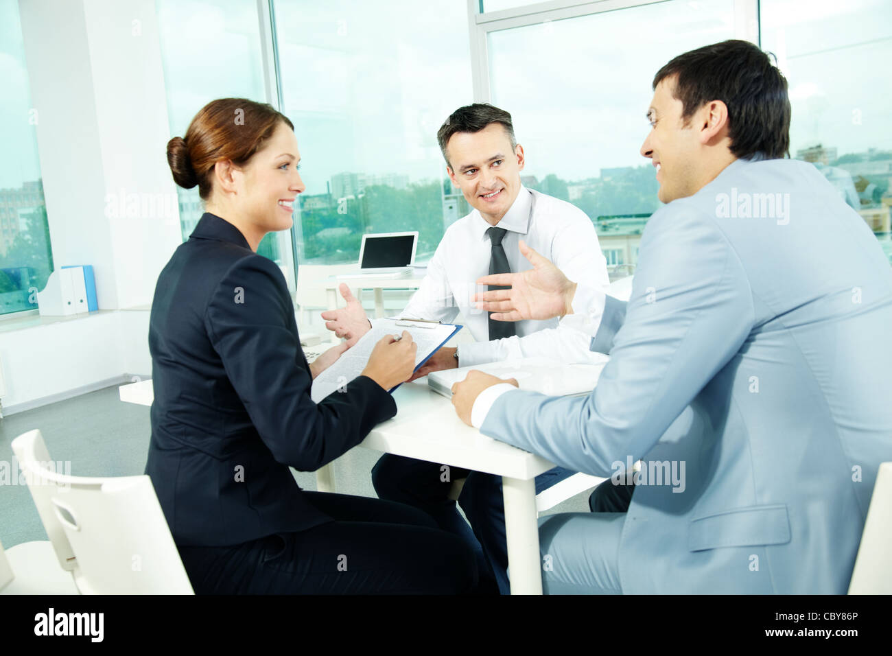Portrait of friendly professionals planning work in office Stock Photo ...
