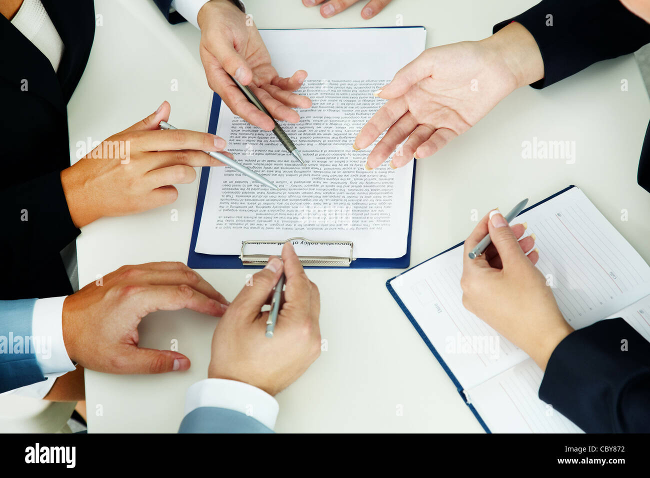 Image of human hands with pens over business document at meeting Stock ...
