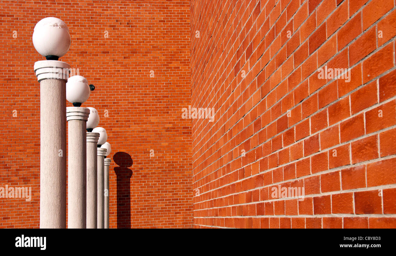 red bricks wall and white columns with lamps Stock Photo - Alamy