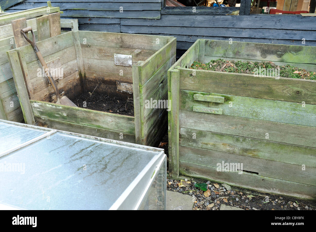 Garden compost, wooden compost bins behind garden potting shed, UK ...