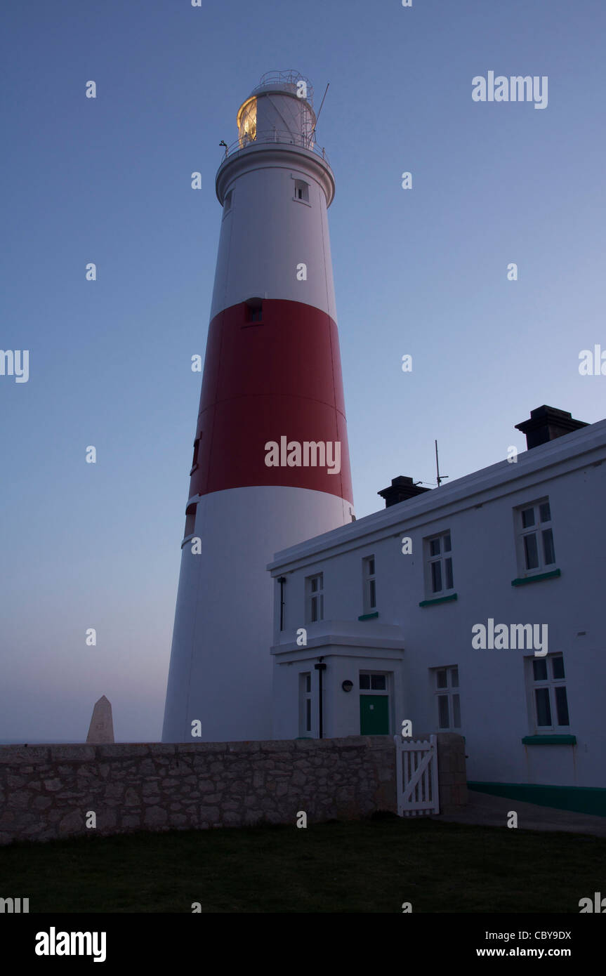 The Trinity House Lighthouse at Portland Bill at twilight. The lamp ...