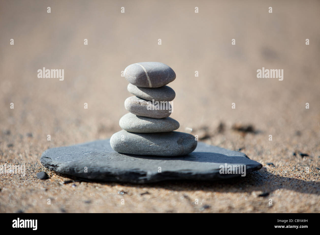 Stones stacked on to of each other on a beach Stock Photo - Alamy