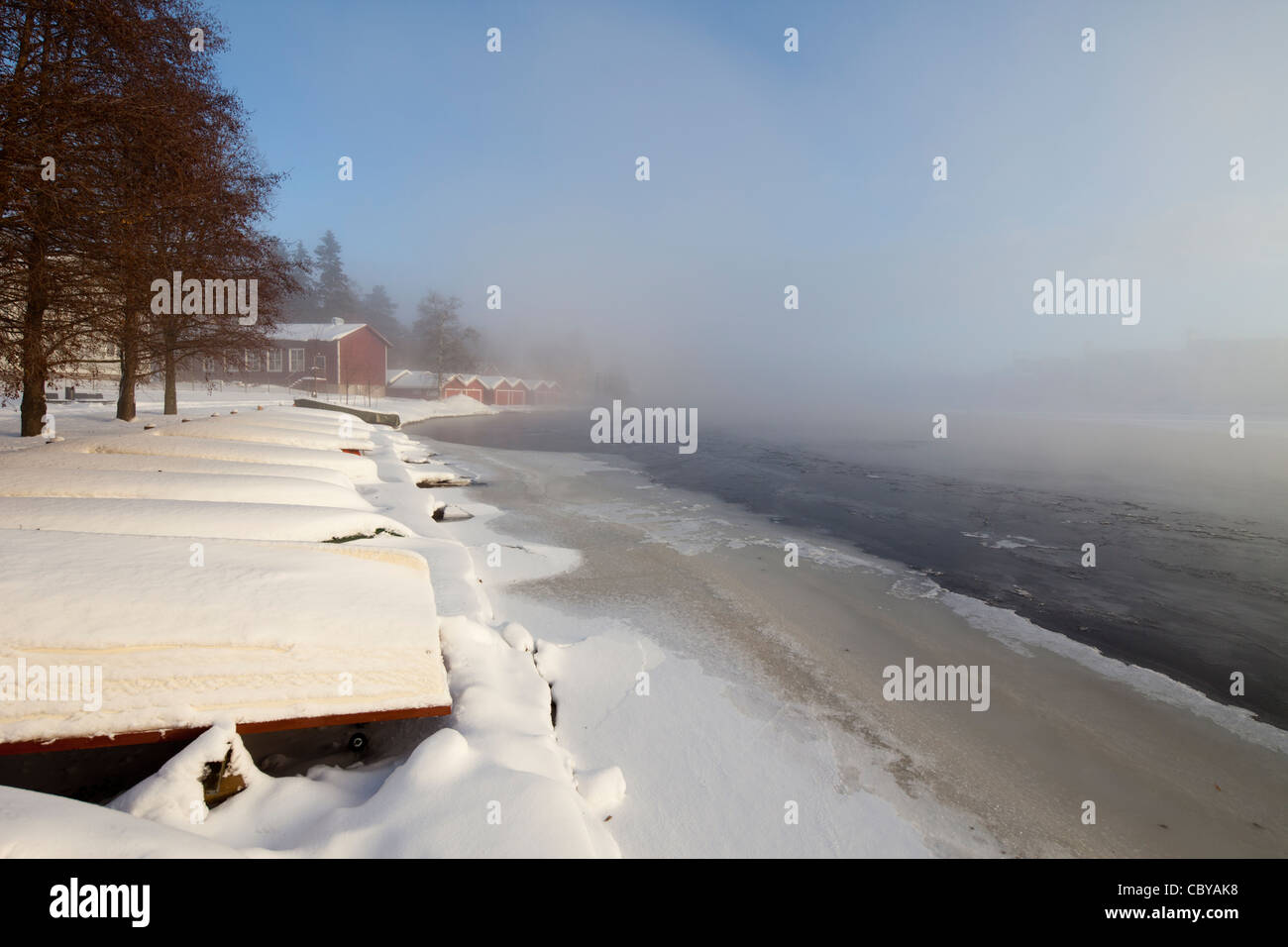 Upturned rowboats / skiffs / dinghies covered with snow at river ...