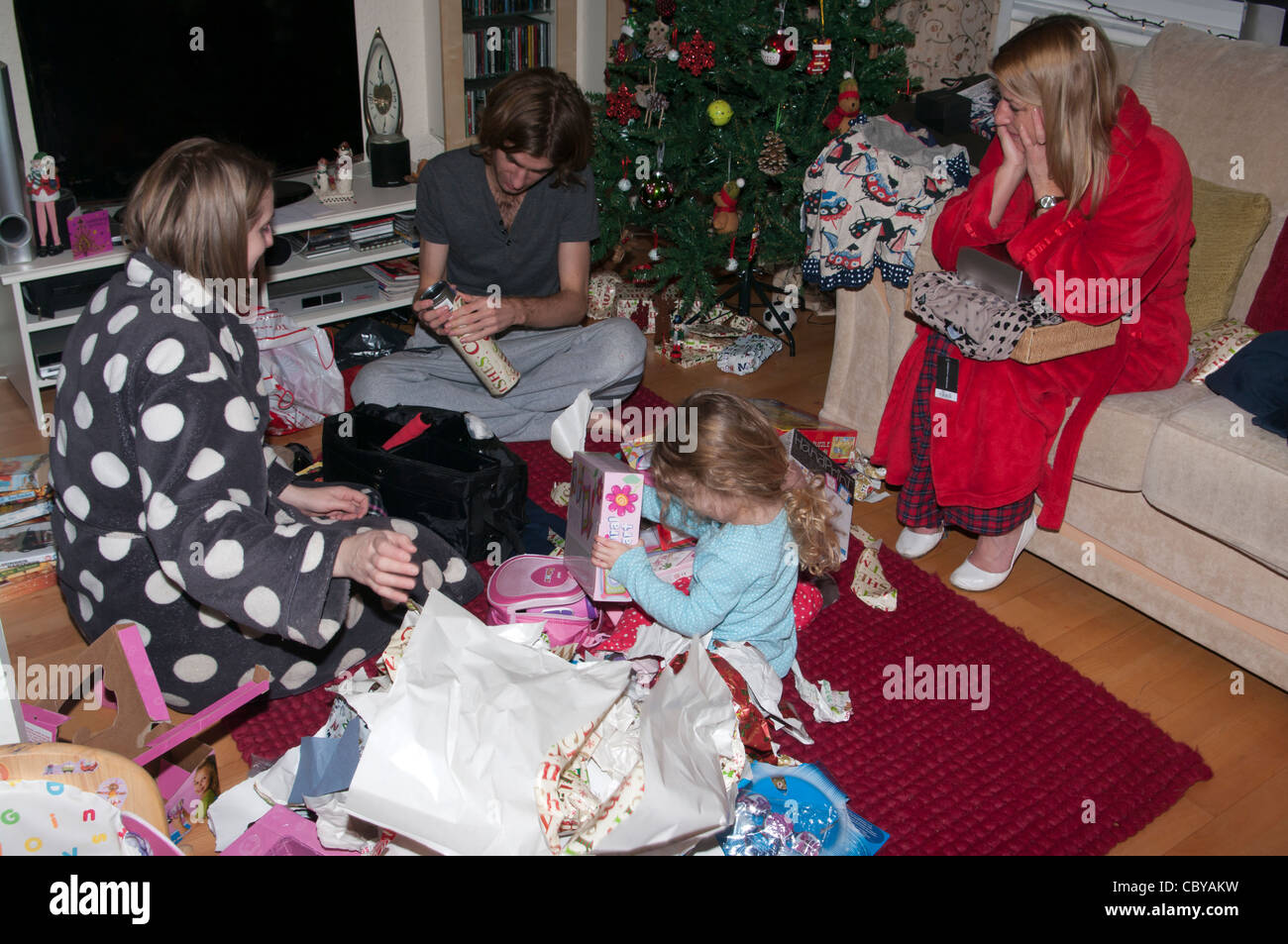 Christmas presents opening adults hi-res stock photography and images ...