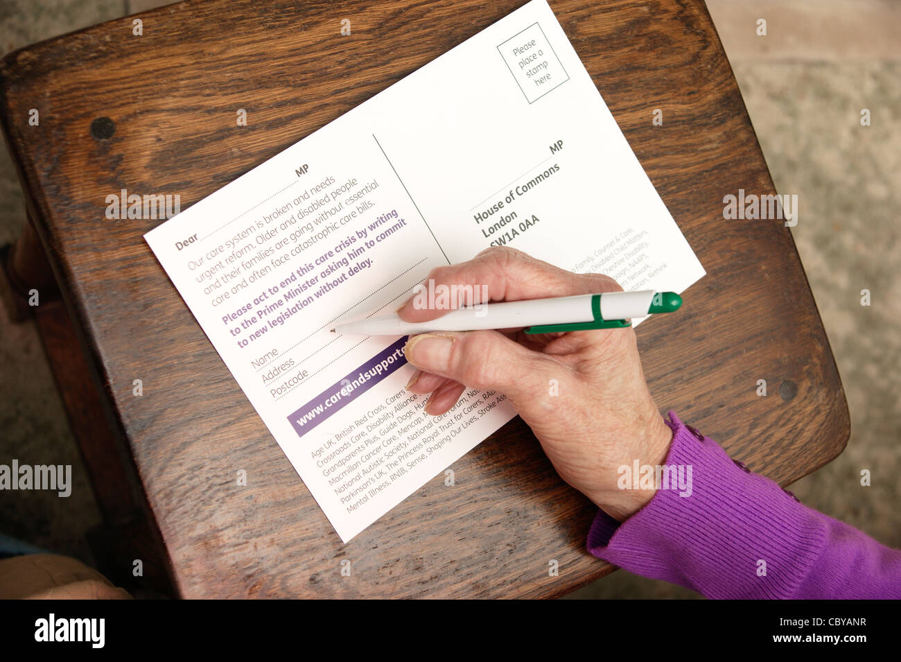 Elderly woman writing to MP to campaign for a better system & rights ...