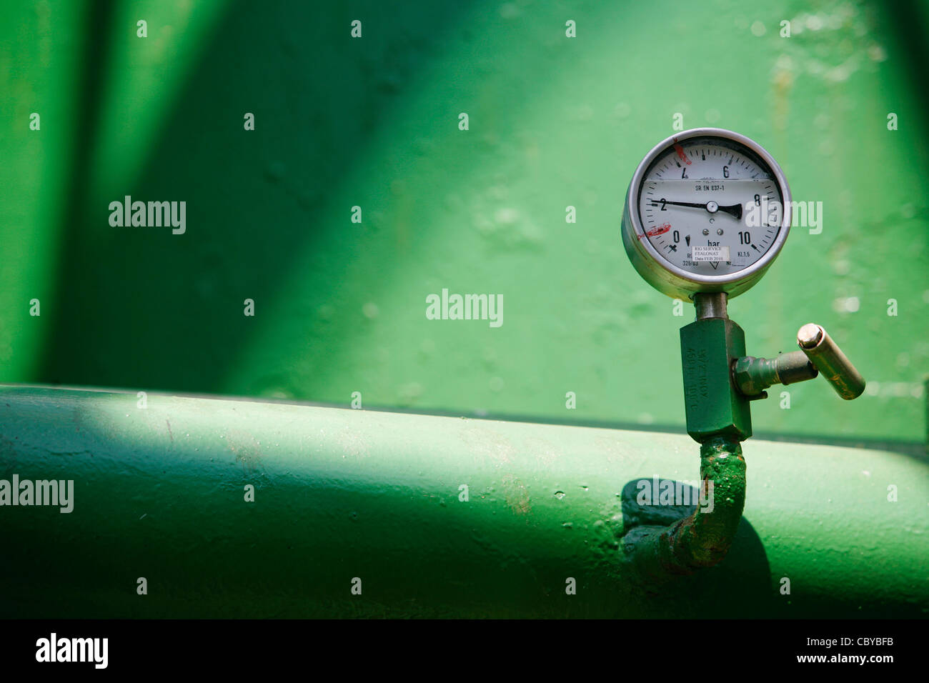 Pressure gauge against a green background Stock Photo - Alamy