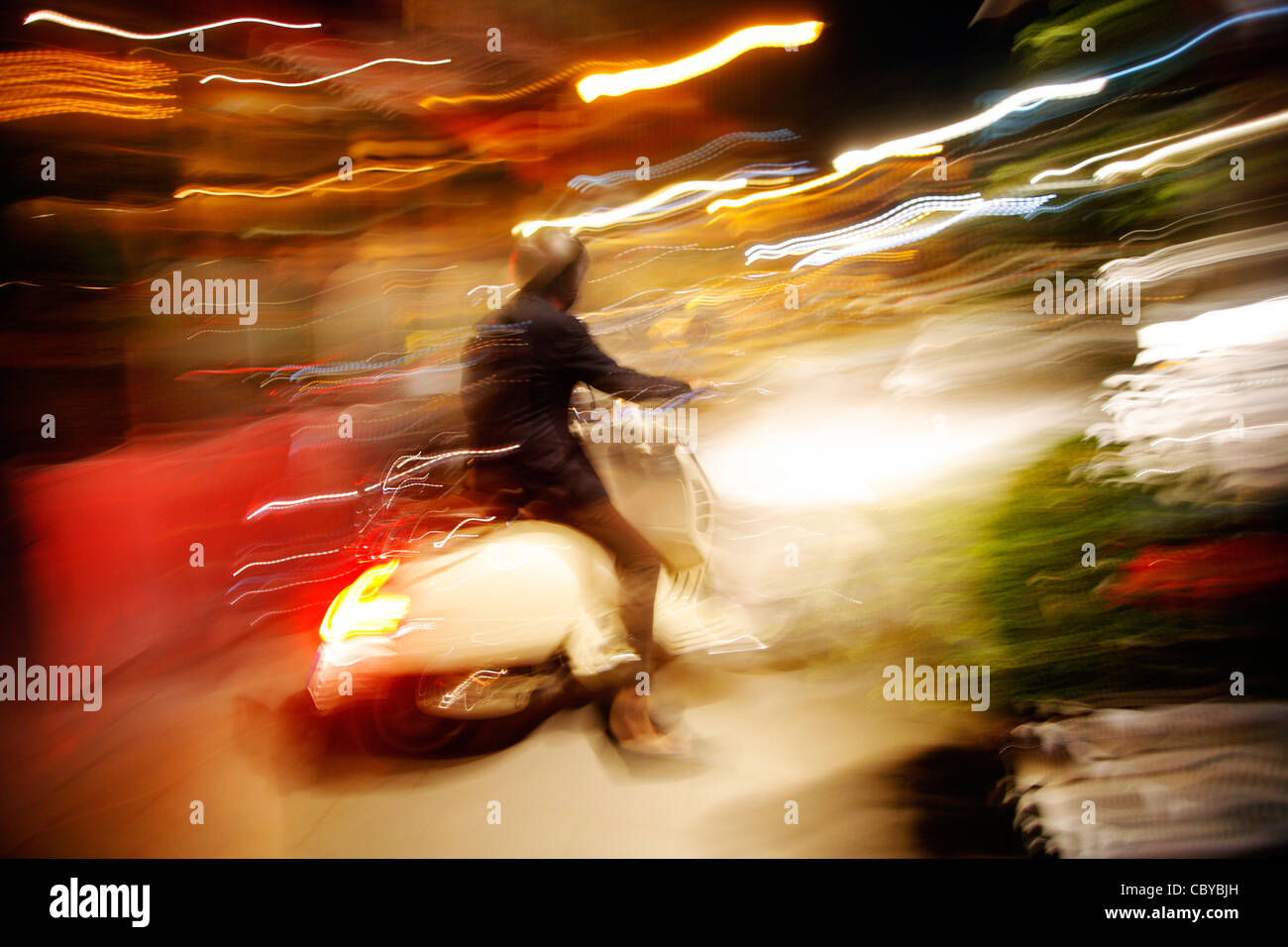 Motion blur picture of a scooter with lots of lights Stock Photo - Alamy
