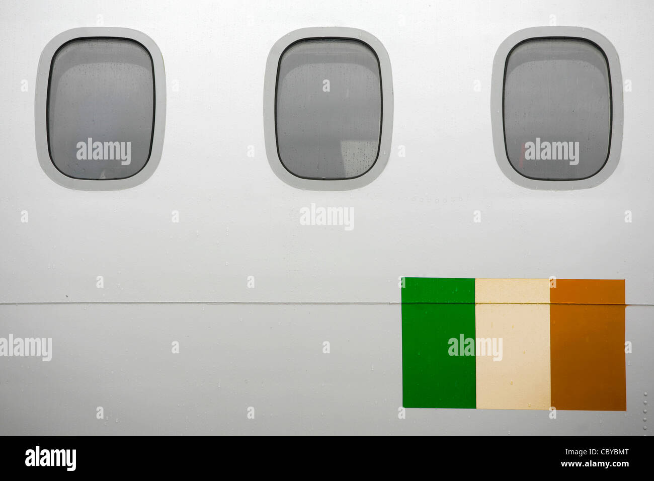 Row of windows of a passenger plane with the Irish flag Stock Photo - Alamy