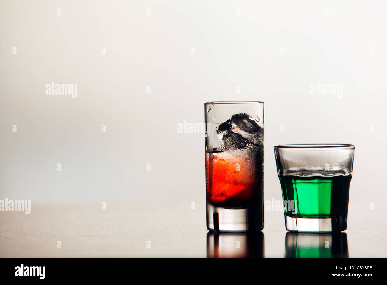 Two colored drinks, a red and a green one Stock Photo - Alamy