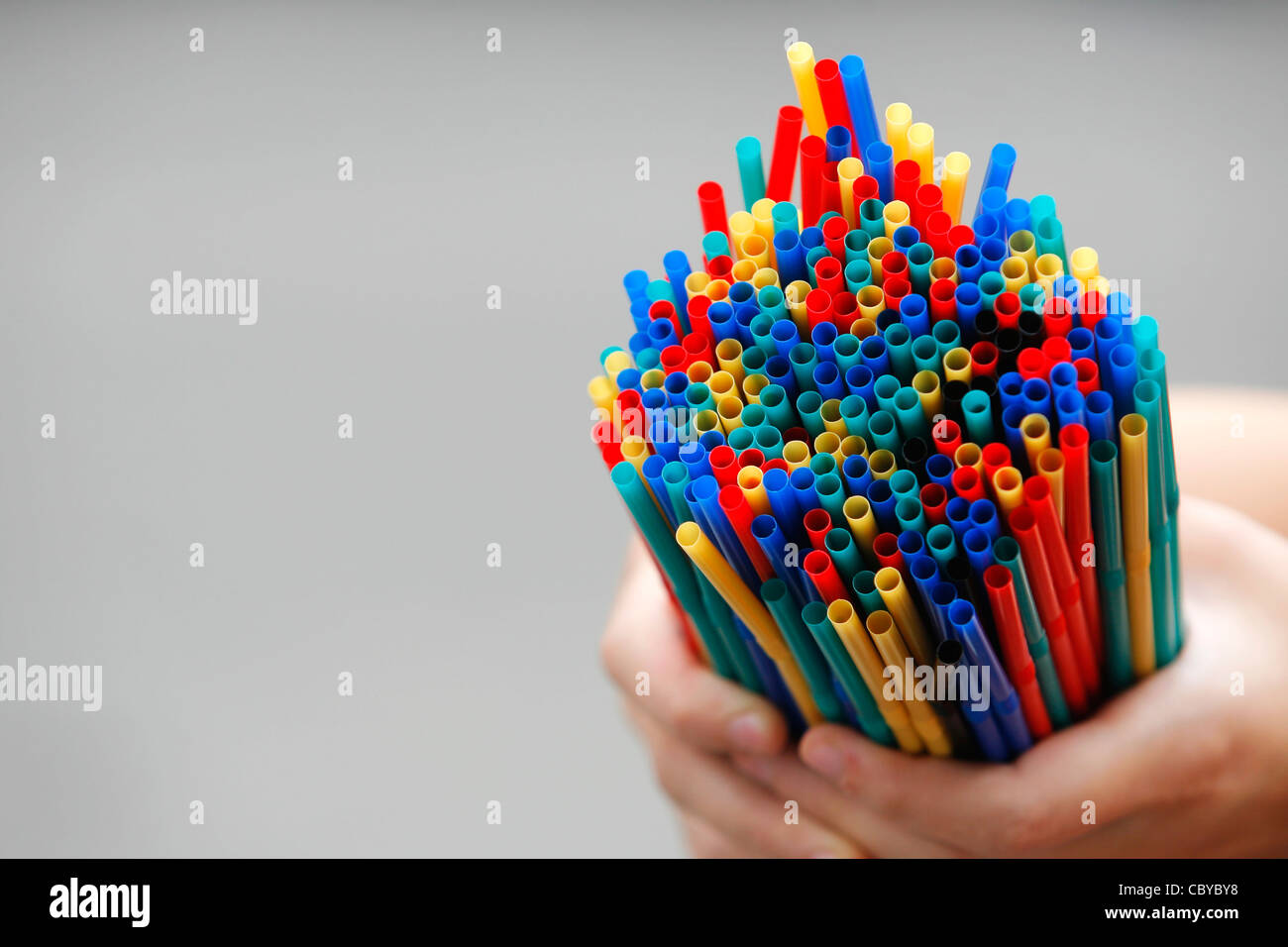 Hand holding many colored straws Stock Photo - Alamy