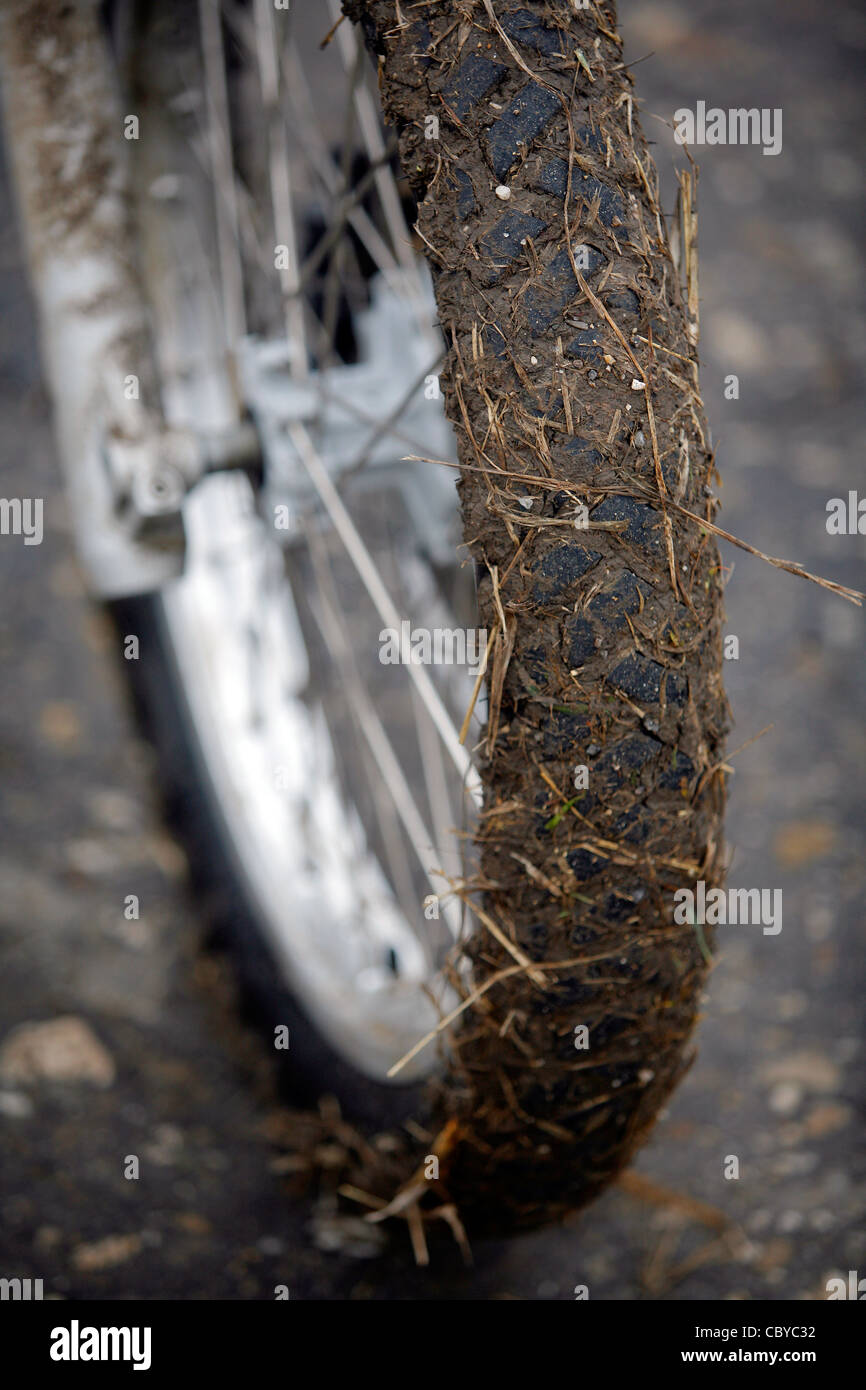 Wheel of a motorcycle full of mud Stock Photo - Alamy