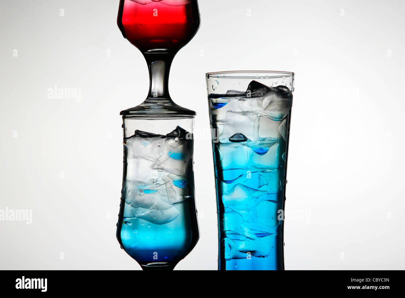 Three colored cocktails against a white background Stock Photo - Alamy