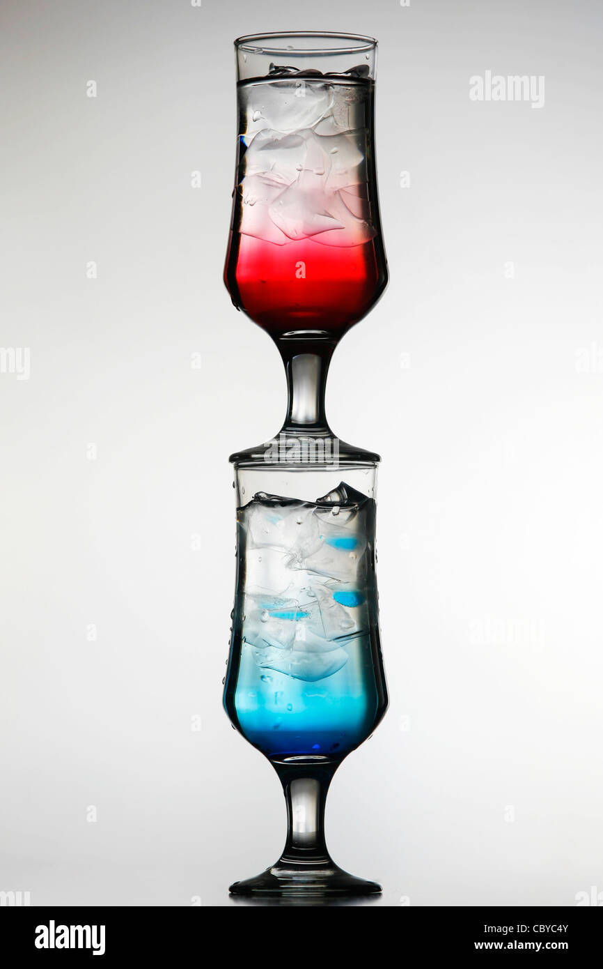 Two colored cocktails against a white background Stock Photo - Alamy