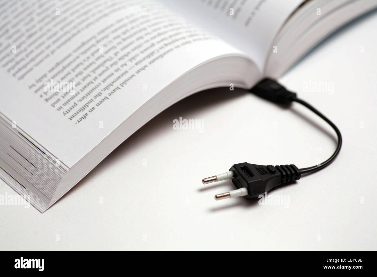 Open book with a power plug Stock Photo - Alamy