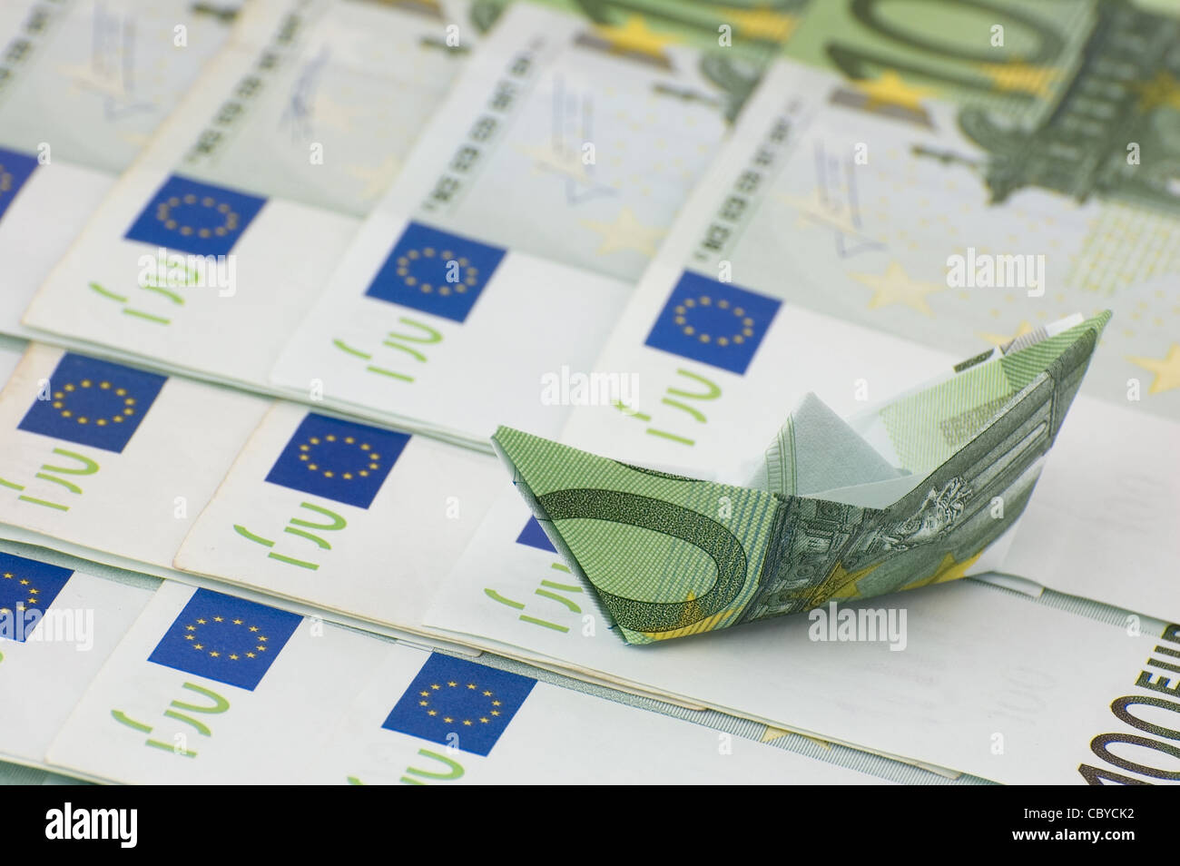 Paper ship made of euro banknote sailing on money Stock Photo - Alamy