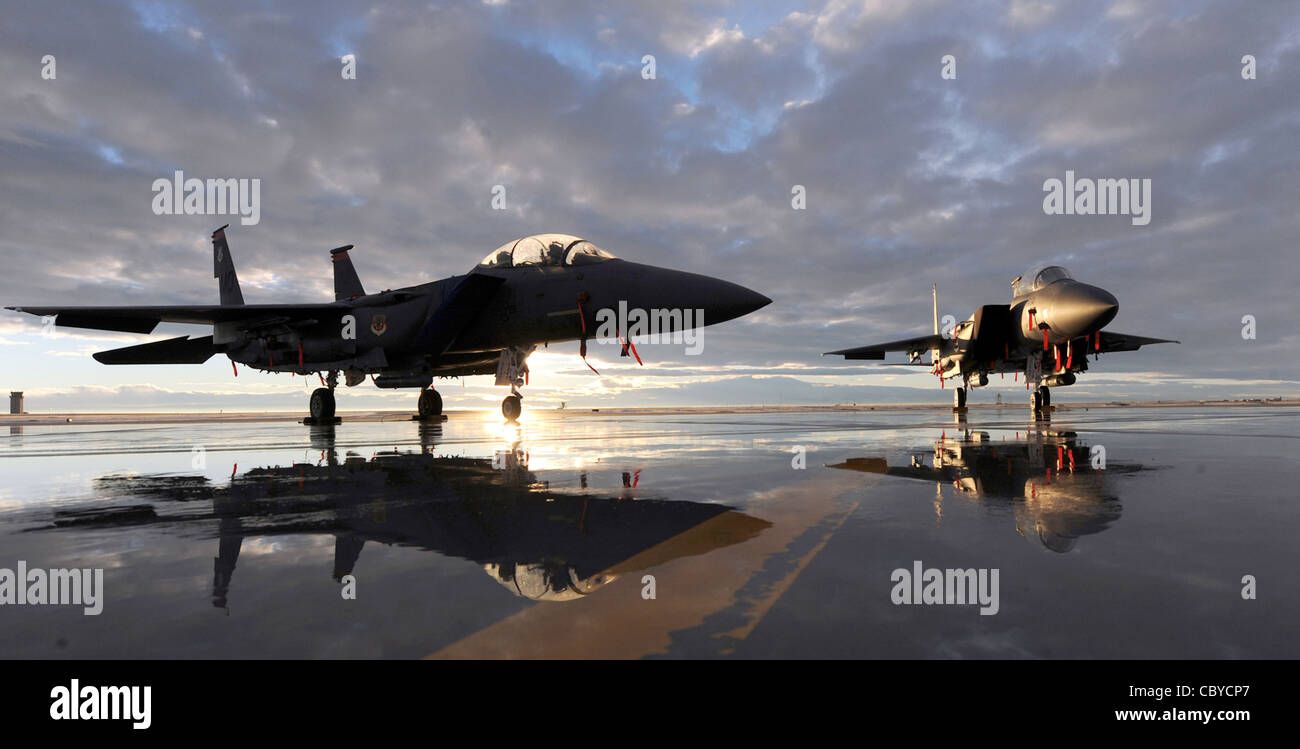 Two F-15E Strike Eagles sit on the flightline during sunset Dec. 6 ...