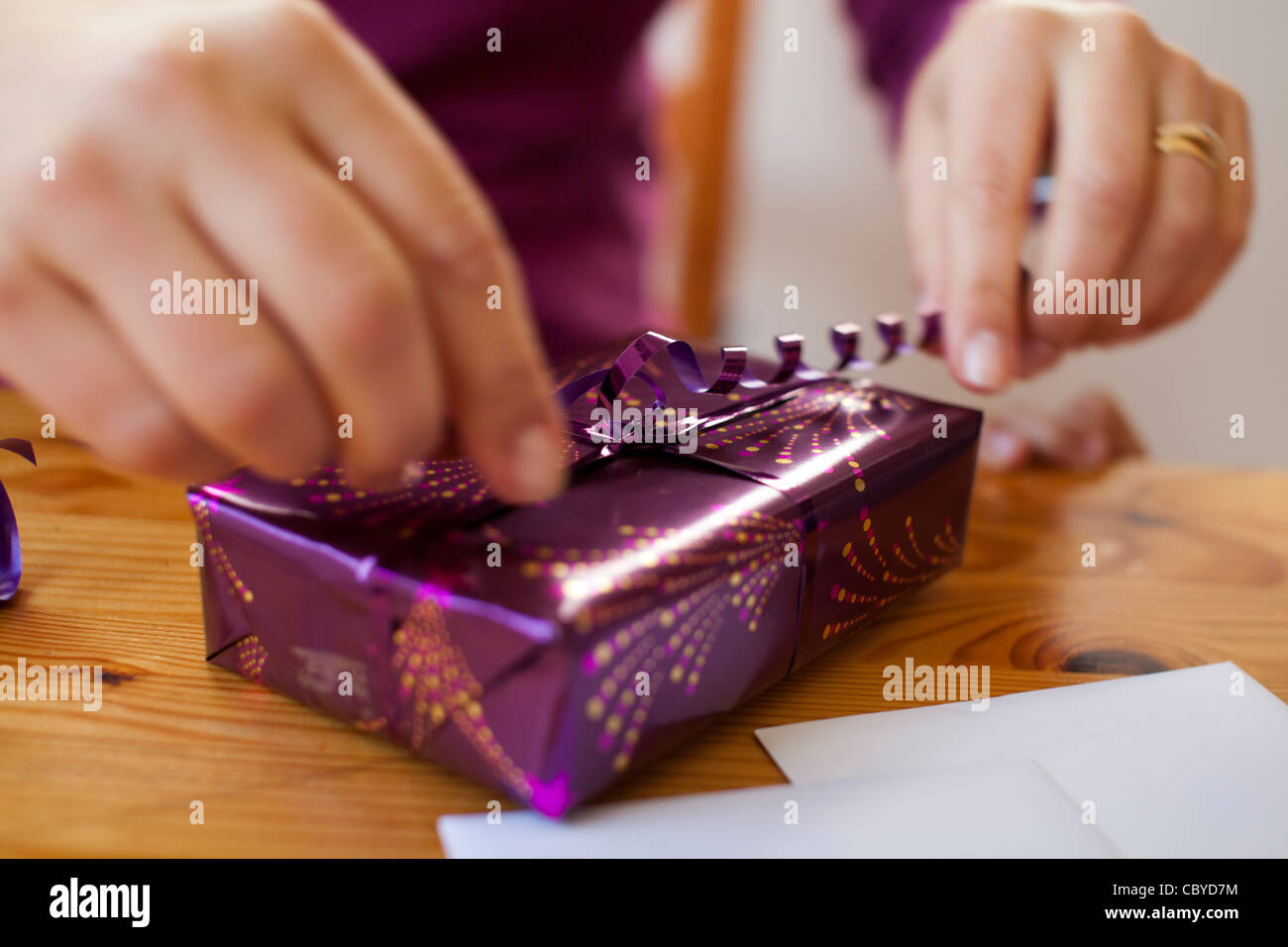 Lady wrapping a Christmas present Stock Photo - Alamy