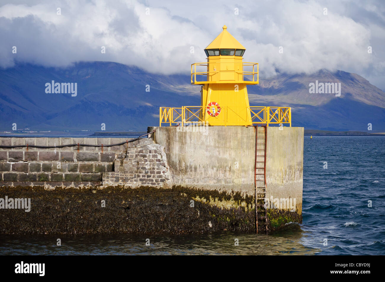 A yellow lighthouse in the bay of Reykjavik, Iceland Stock Photo - Alamy